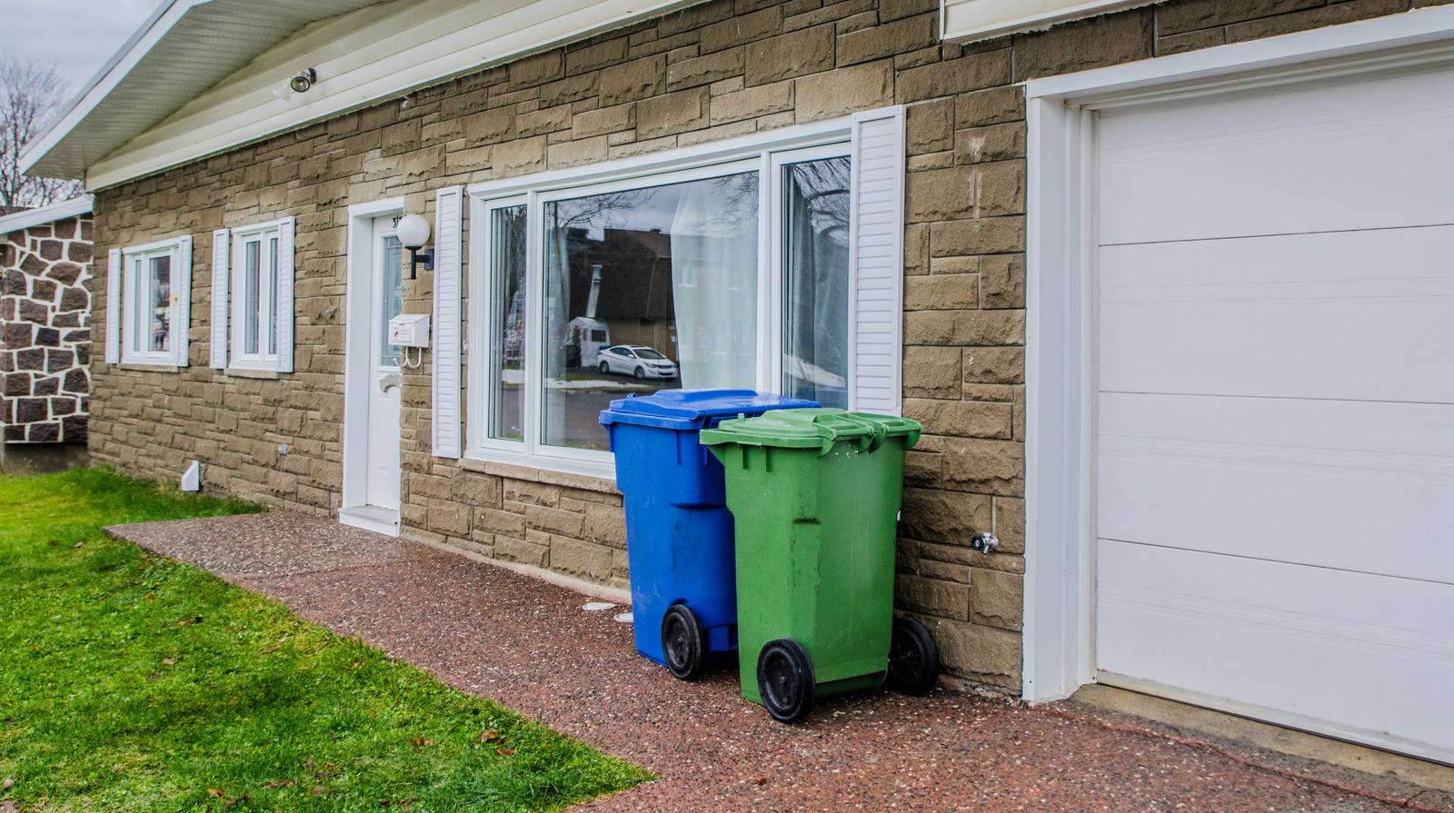 Repurpose Old Doors For An Outdoor Barrier To Hide Your Garbage Cans